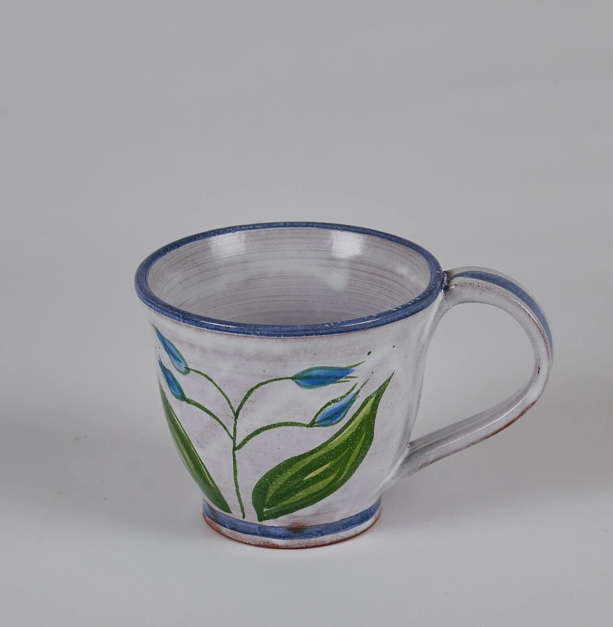 Ceramic Tea Cup with Blue Flower Design — Gillshaw Pottery in Sussex