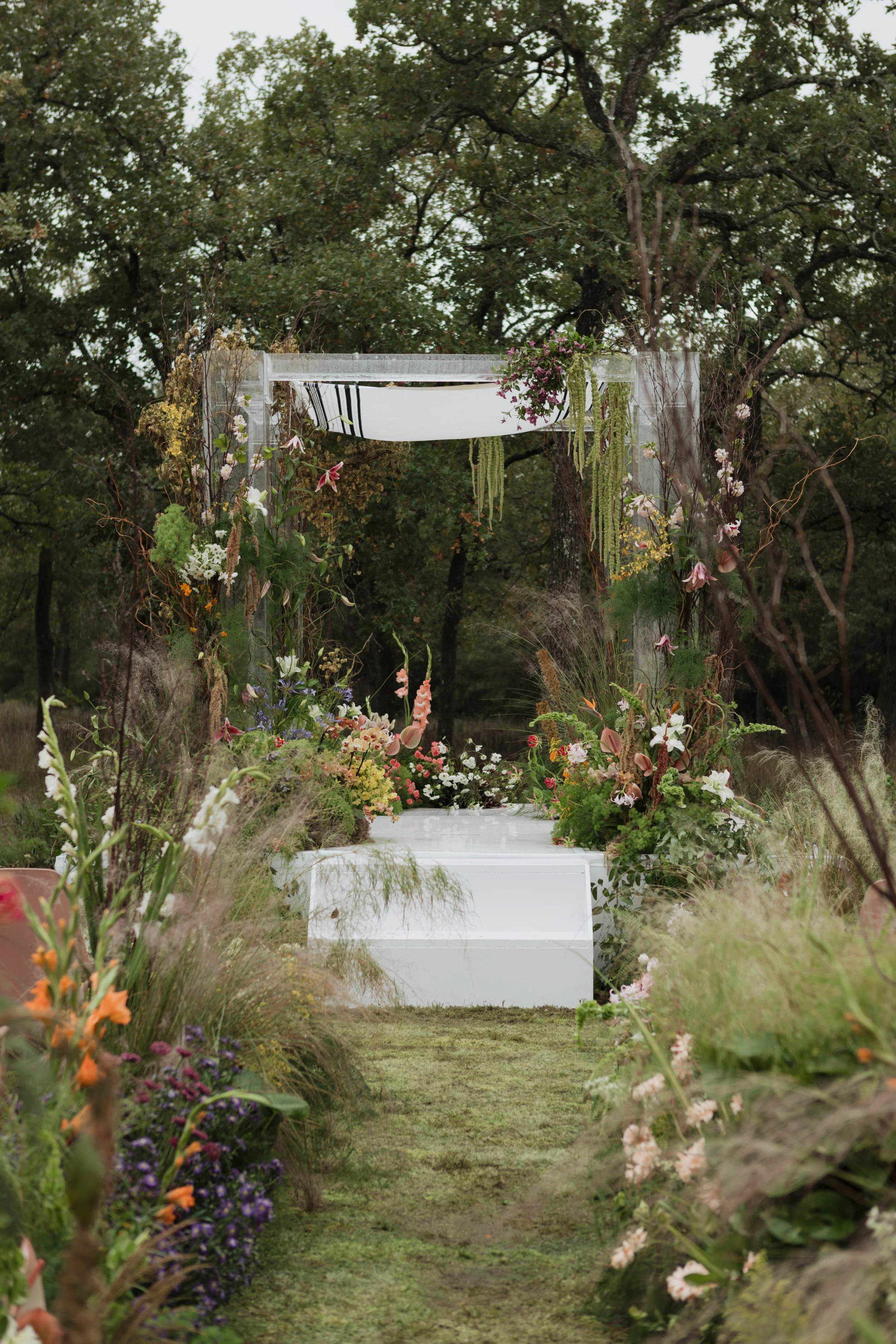 Overgrown Ceremony Aisle Flowers inspired by Alice in Wonderland