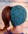 Knitting pattern for a ponytail hat with buttons that let you position ...