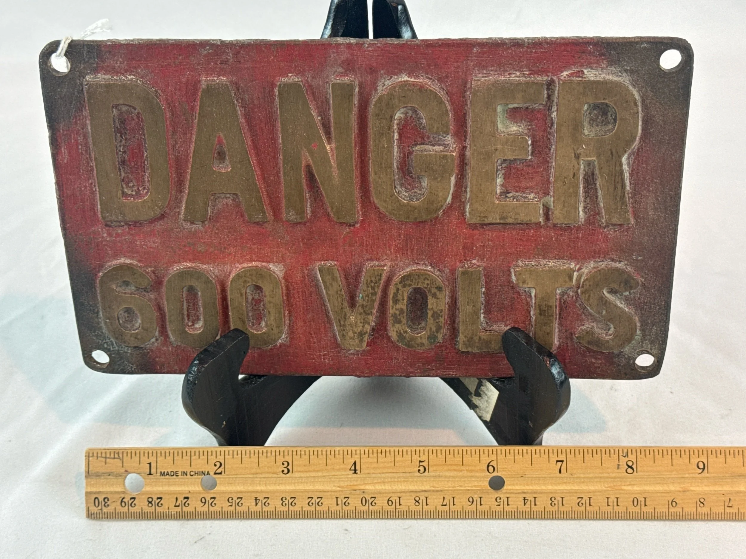vintage or antique cast metal "DANGER 600 VOLTS" warning sign. — The ...